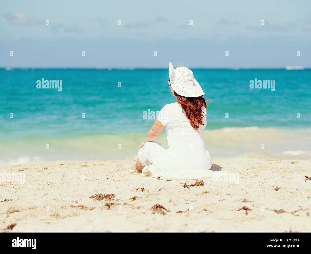 Woman in white clothes on the beach on sunny day Stock Photo - Alamy