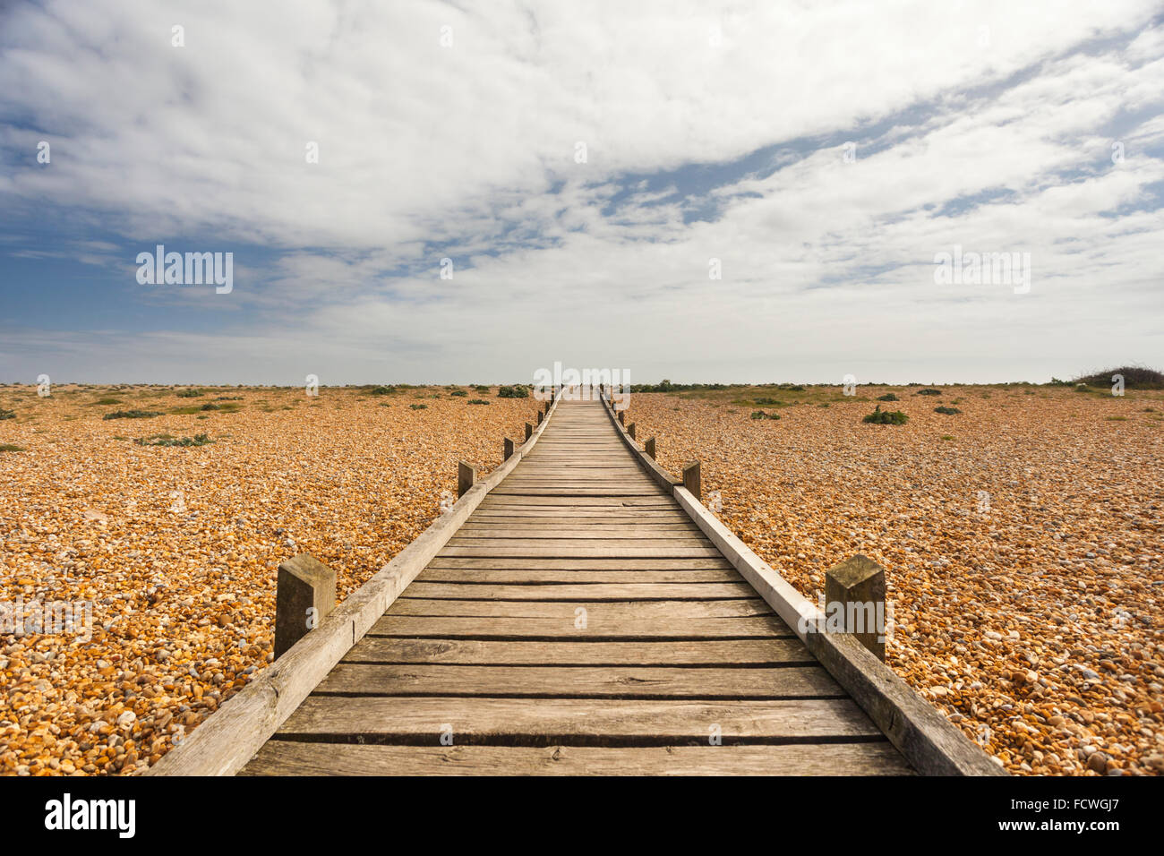 Wood sleeper boardwalk path across the empty shingle beach in Dungeness ...