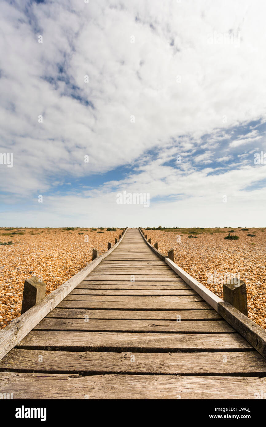 Wood sleeper boardwalk path across the empty shingle beach in Dungeness ...
