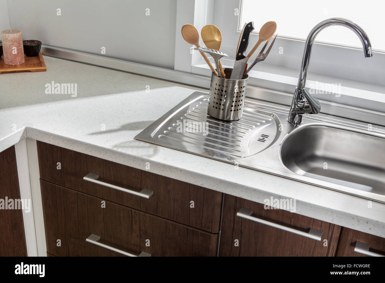 Part of modern kitchen sink with drawers and handles Stock Photo - Alamy