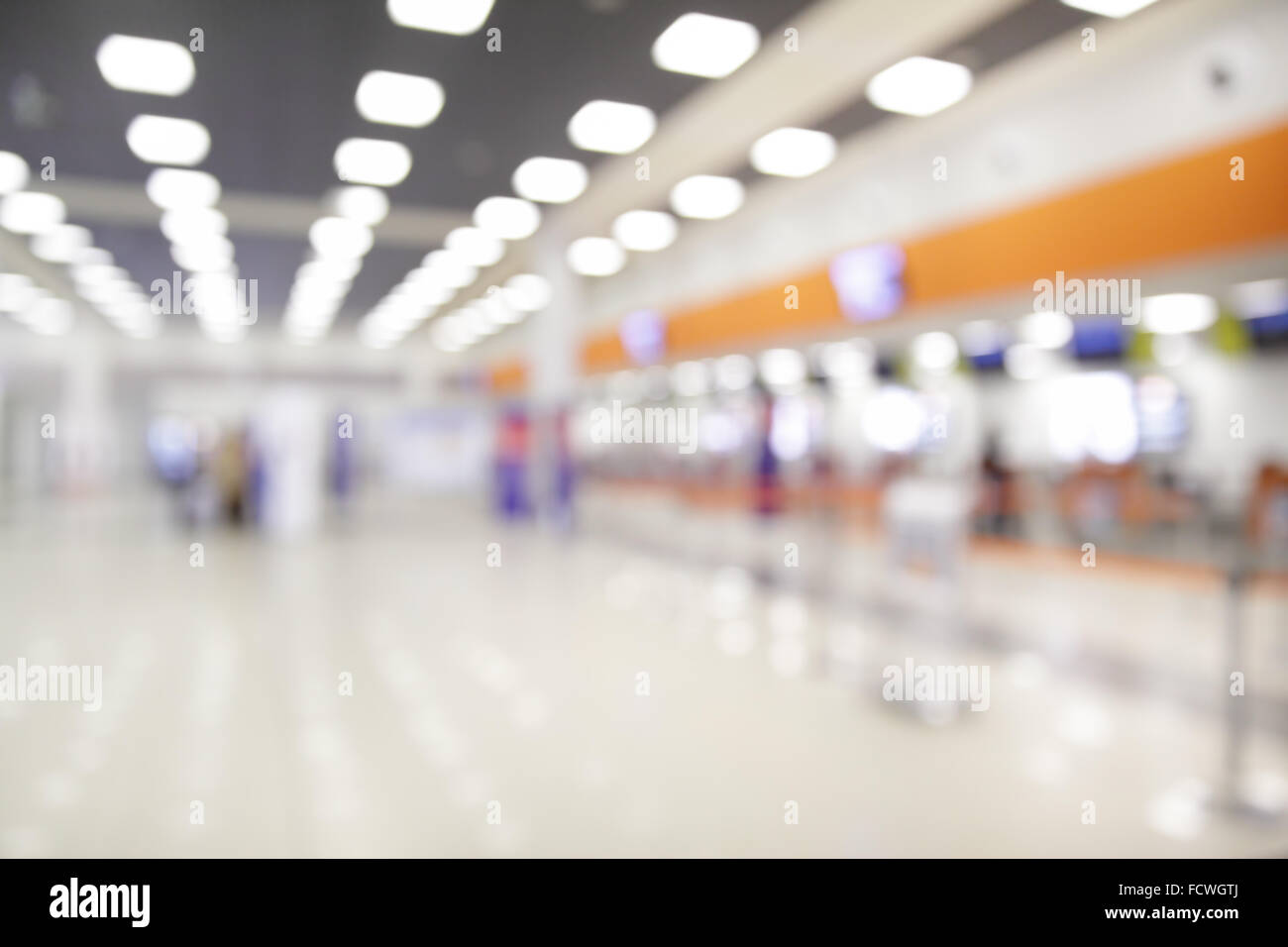 Check-in counters in airport - Defocused background Stock Photo - Alamy