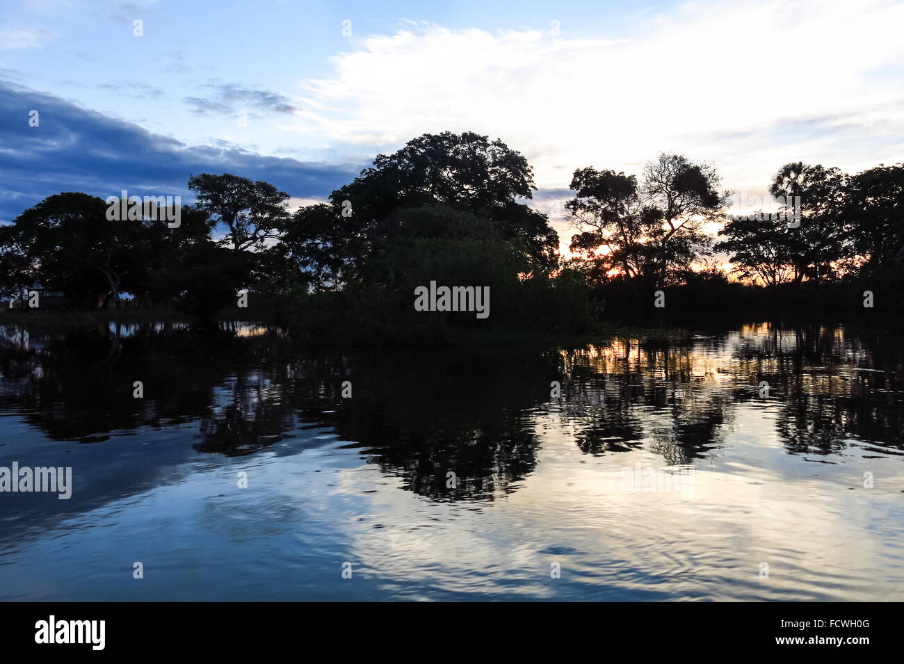 Sunset. Boat Crossing the Amazon. Beni region, Pampas de Yacuma ...