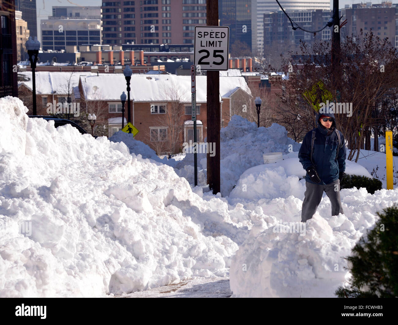 Washington, DC, USA. 25th Jan, 2016. A man walks by hummocked snow on a ...