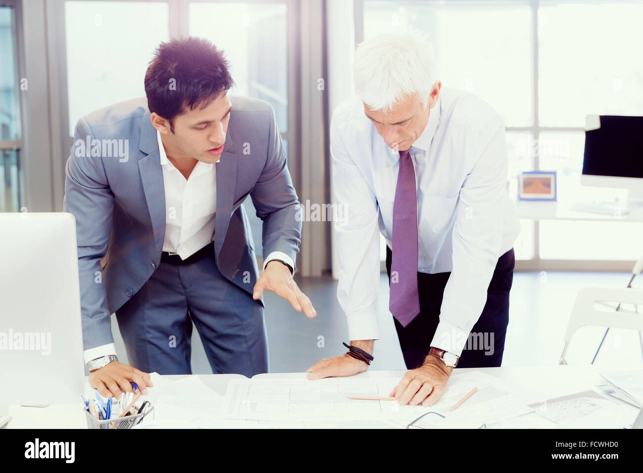 Two businessman in office having discussion Stock Photo - Alamy