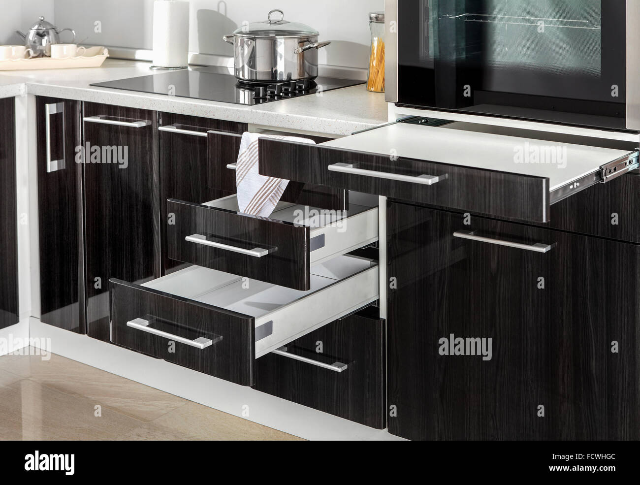 Part of modern kitchen with electric stove oven details, drawers and ...