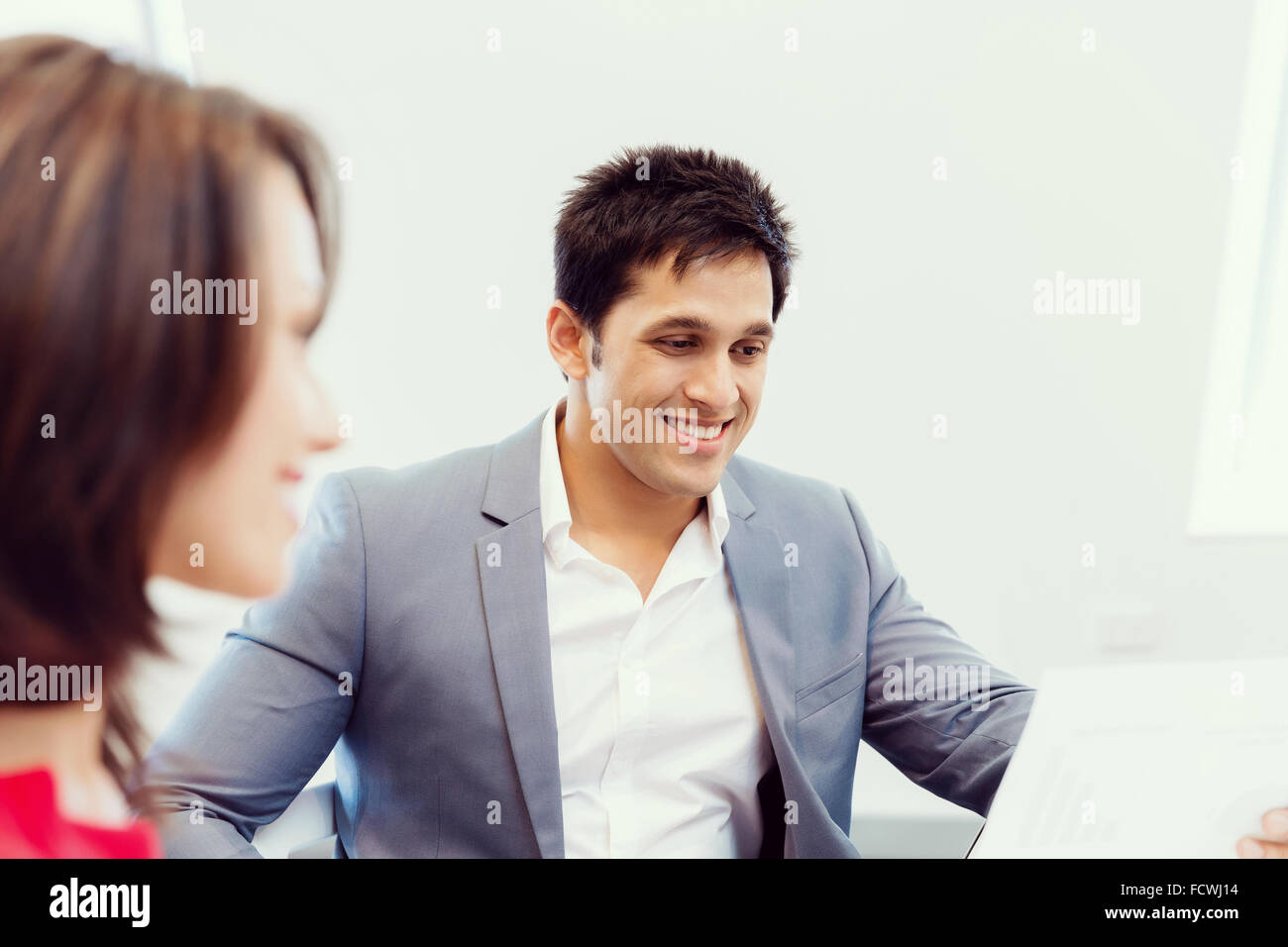 Two young business collegue talking in office Stock Photo - Alamy