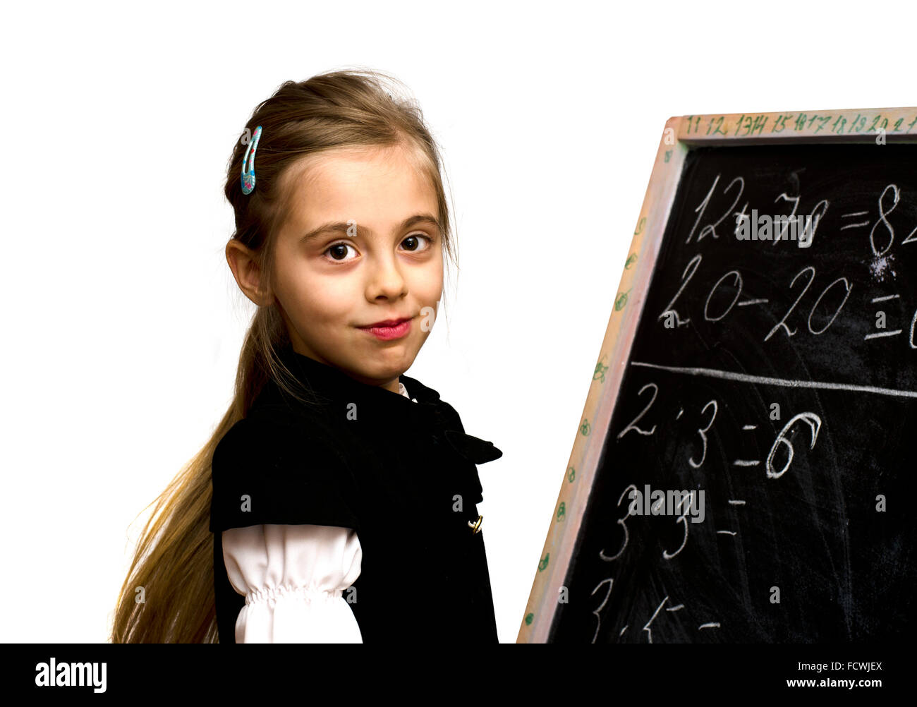 smiling schoolgirl standing near the blackboard Stock Photo - Alamy