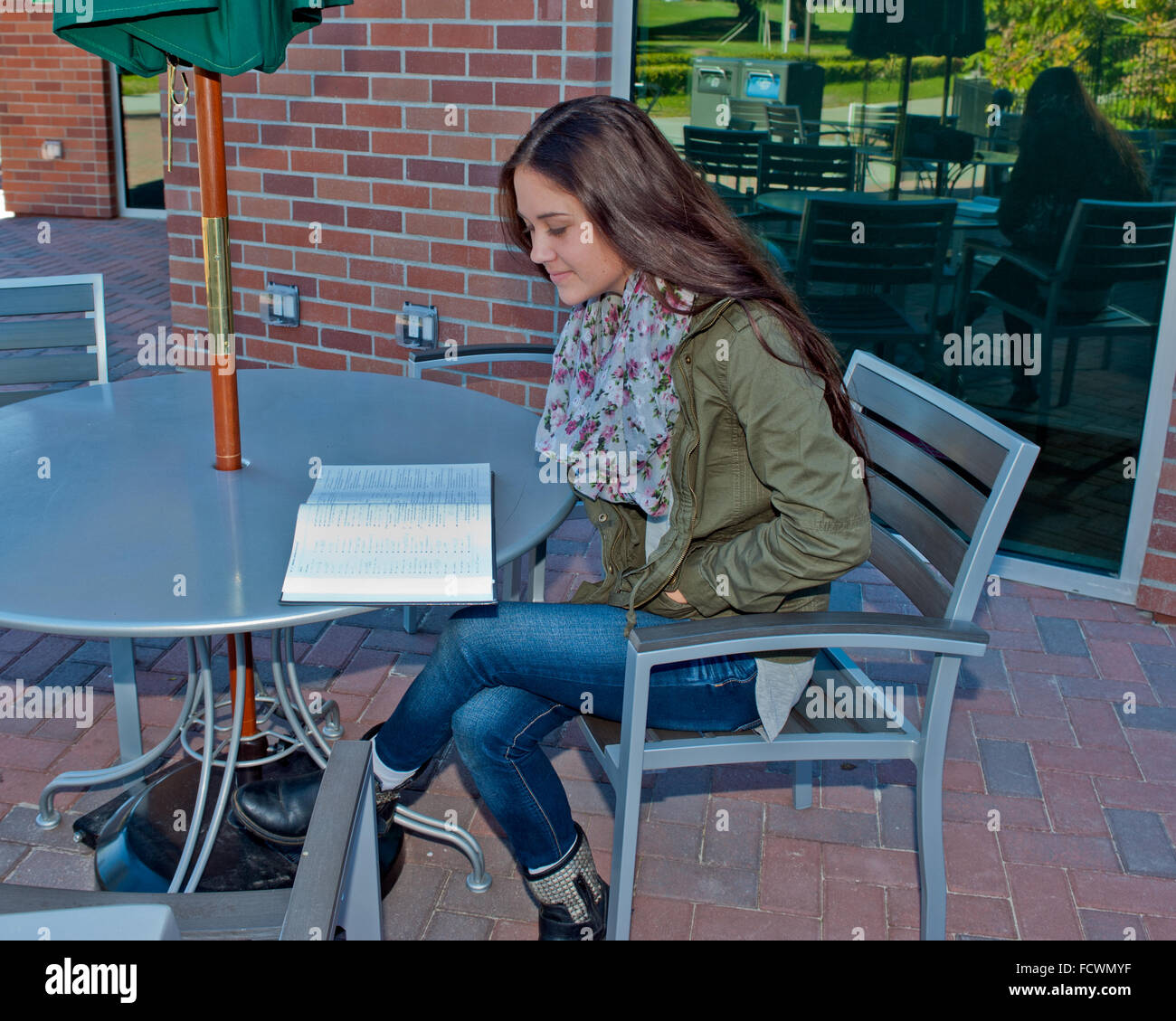 College student studying and her reflection Stock Photo - Alamy