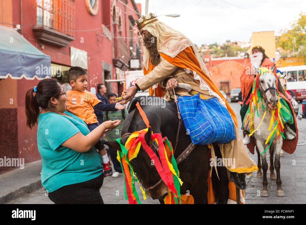 The Three Kings ride by horseback through the cobble streets handing ...