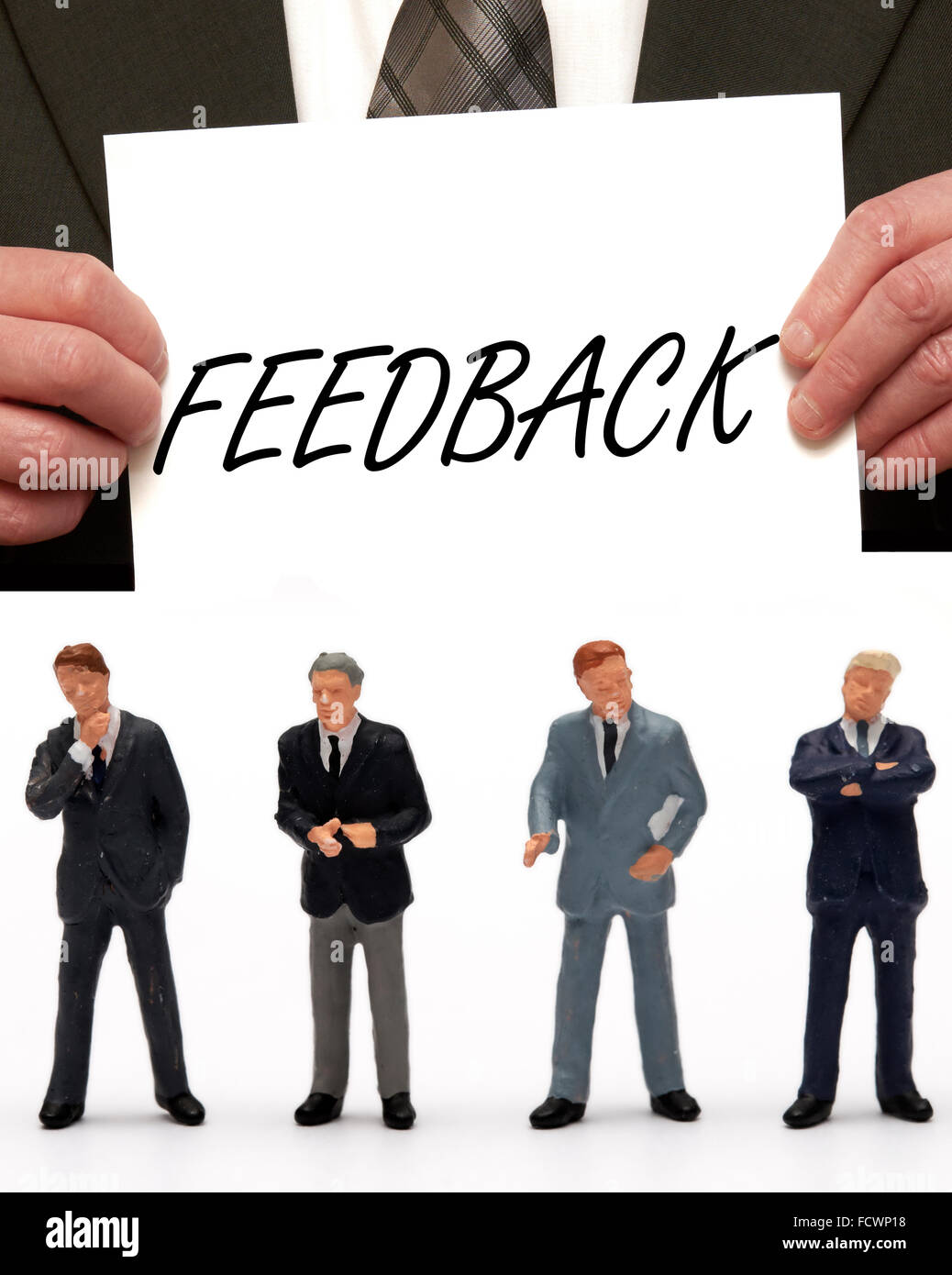 Miniature figurine Business men dressed in suits under the message ...