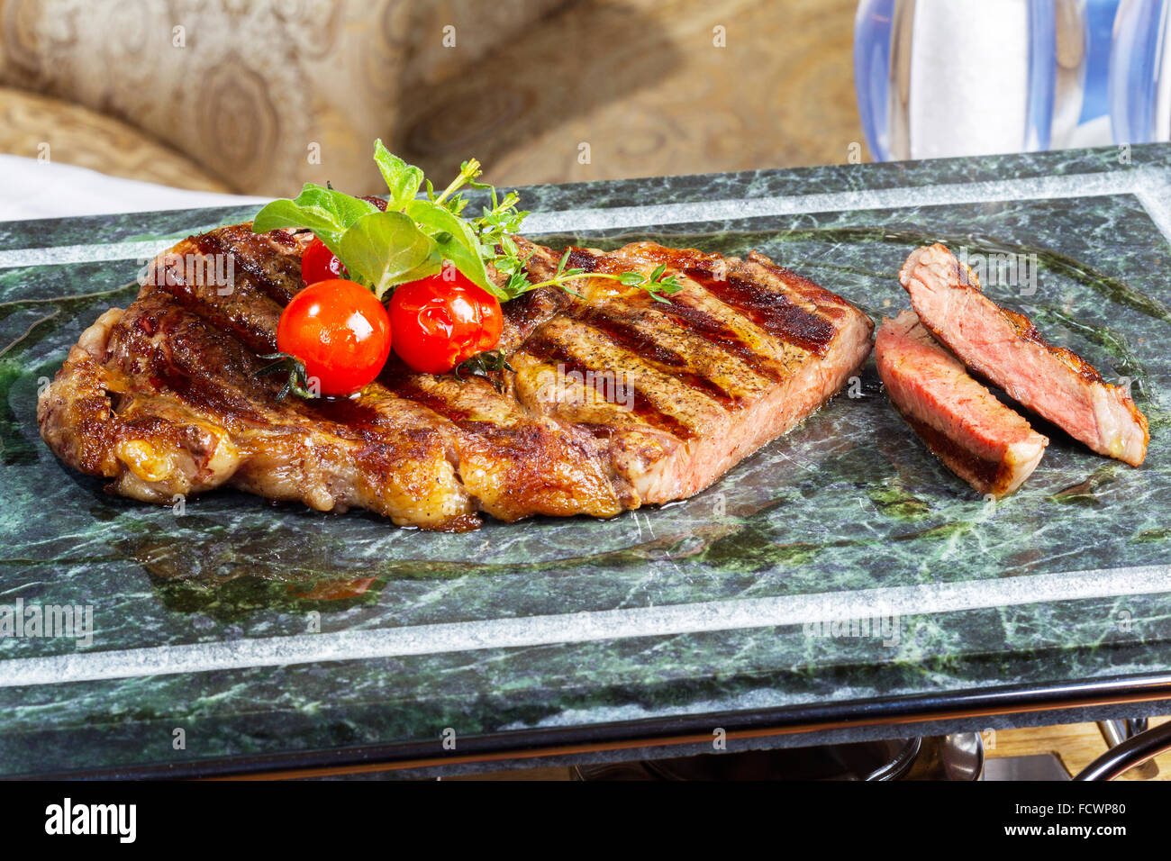 grilled meat with tomatoes on a marble tray Stock Photo - Alamy
