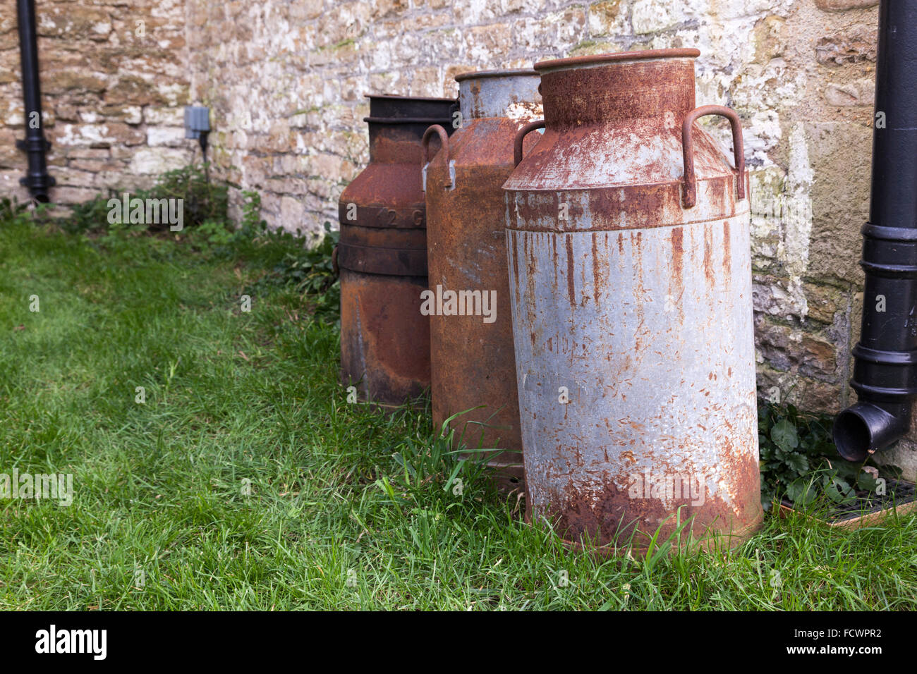 3 rusting milk cans hi-res stock photography and images - Alamy