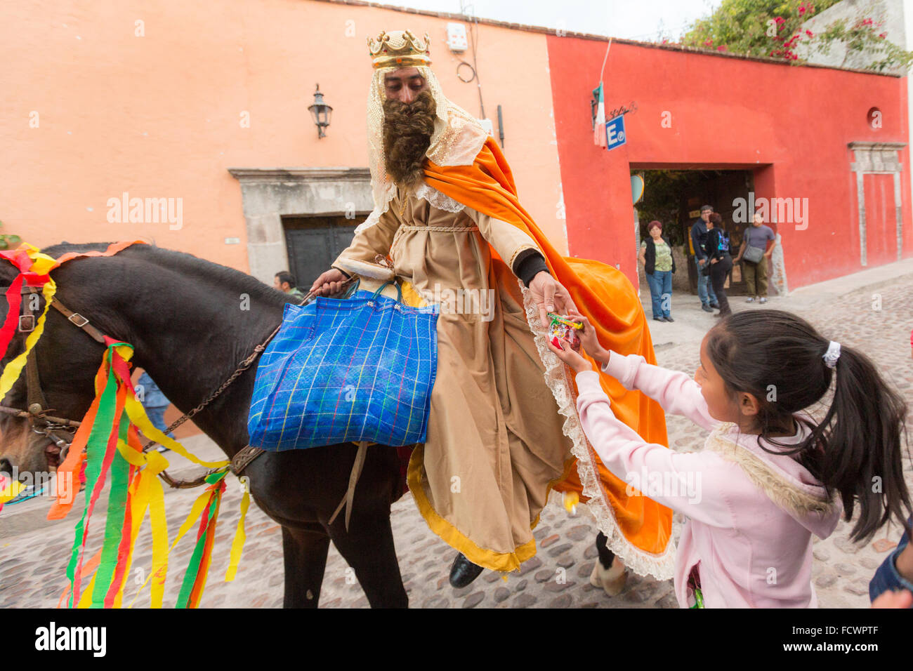 The Three Kings ride by horseback through the cobble streets handing ...