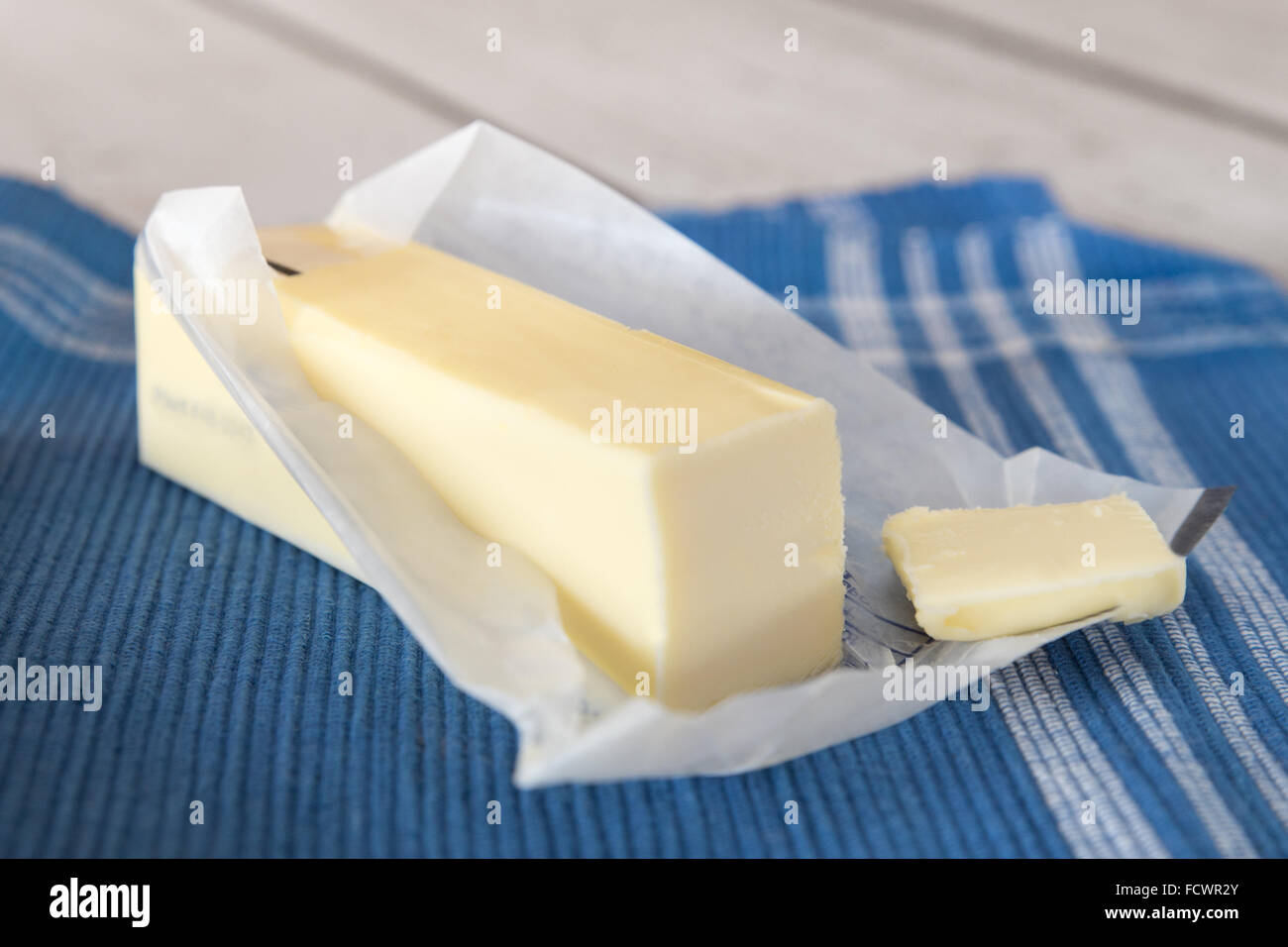 stick of fresh creamery butter in opened wrapper Stock Photo - Alamy