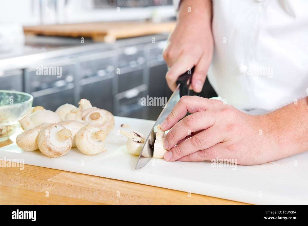 Professional chef cutting mushrooms in the kithcen Stock Photo - Alamy