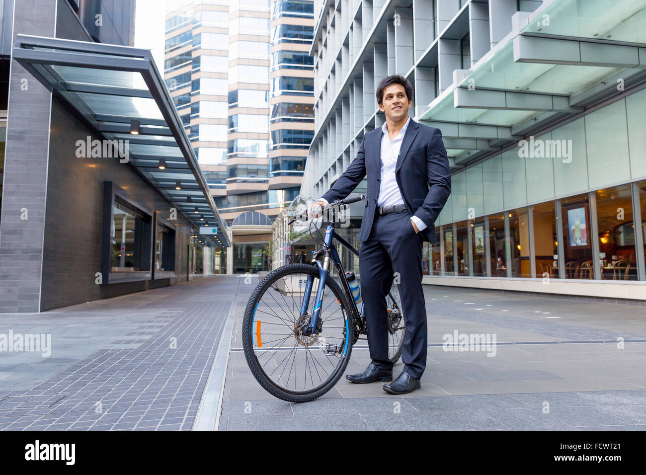 Successful businessman in suit riding bicycle Stock Photo - Alamy