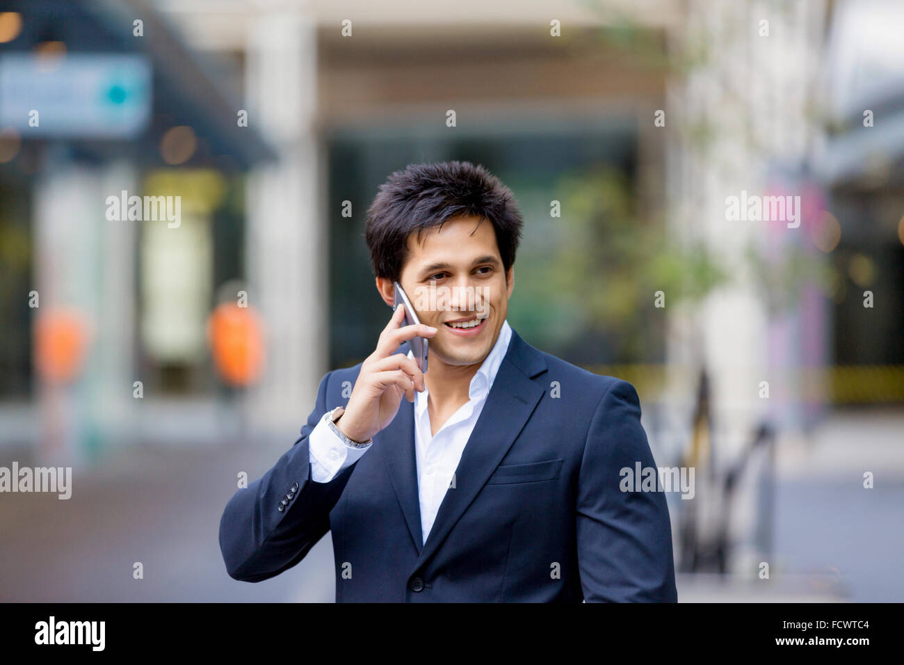 Portrait of confident businessman holding hs mobile phone outdoors Stock Photo - Alamy