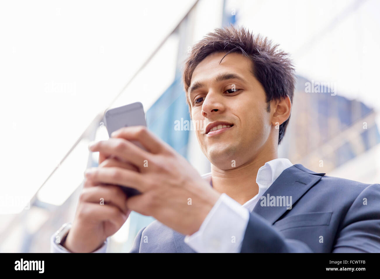 Portrait of confident businessman holding hs mobile phone outdoors Stock Photo - Alamy