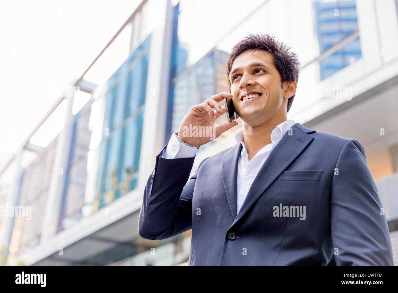 Portrait of confident businessman holding hs mobile phone outdoors Stock Photo - Alamy