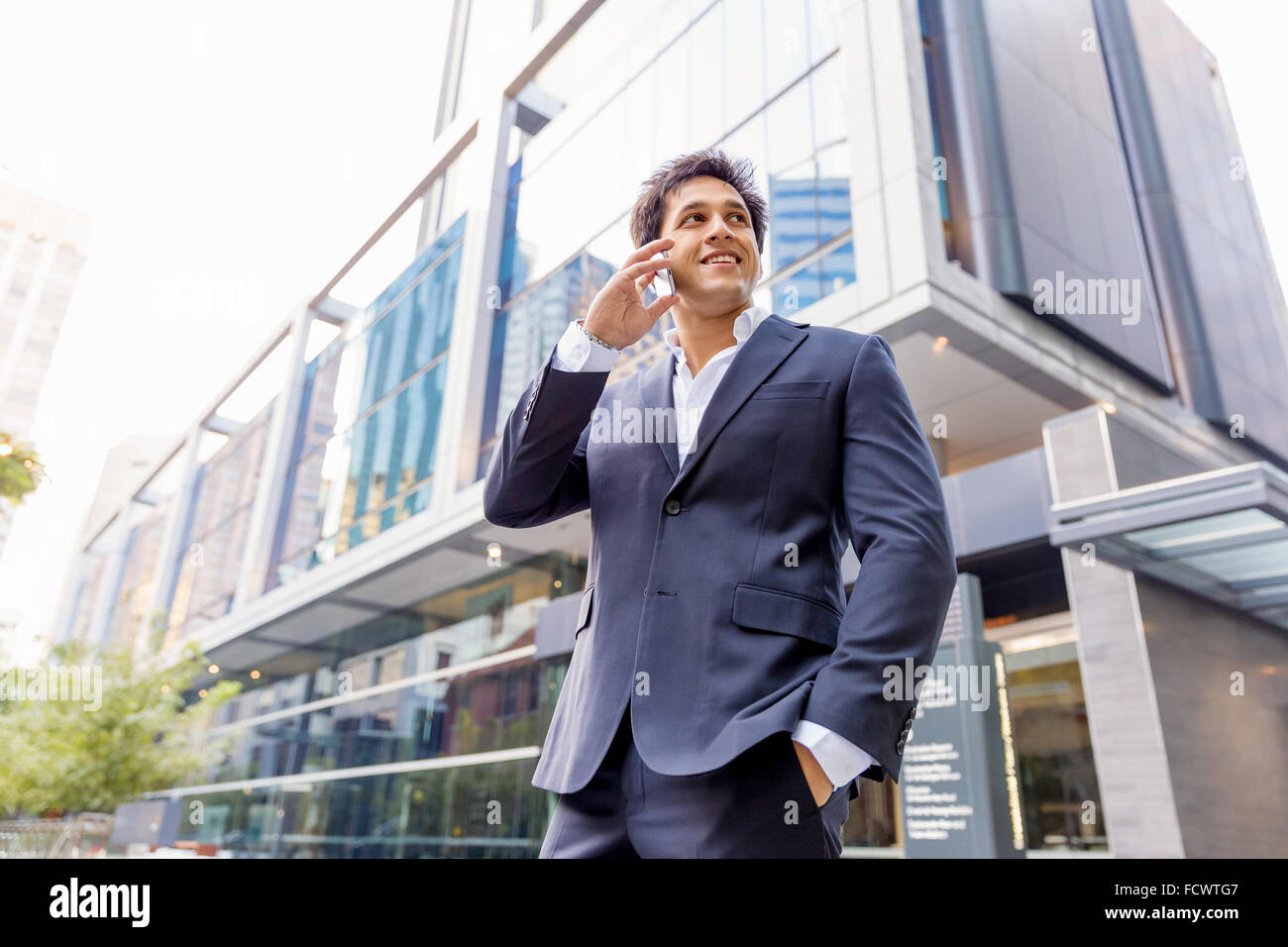 Portrait of confident businessman holding hs mobile phone outdoors Stock Photo - Alamy