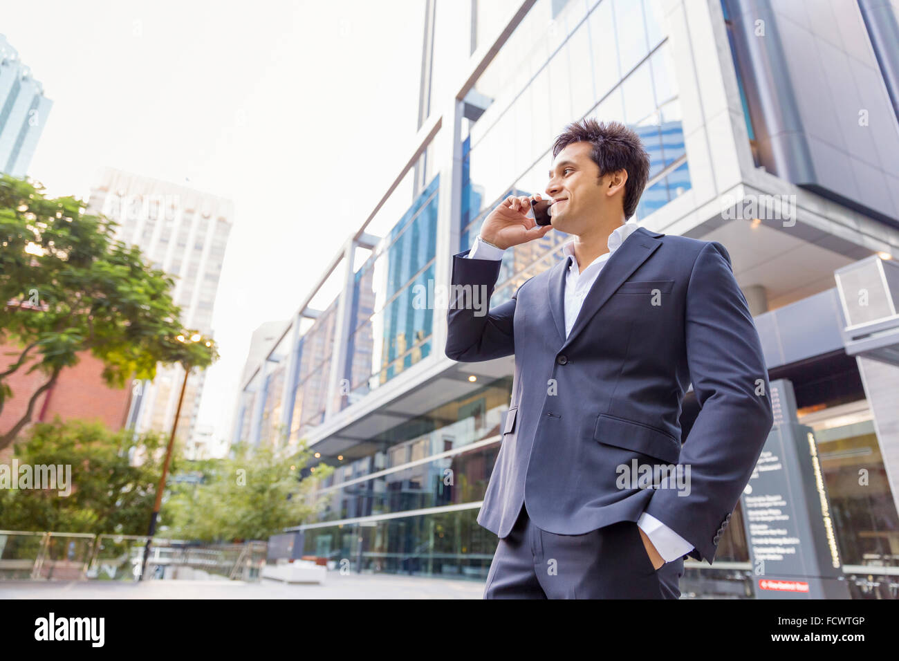 Portrait of confident businessman holding hs mobile phone outdoors Stock Photo - Alamy