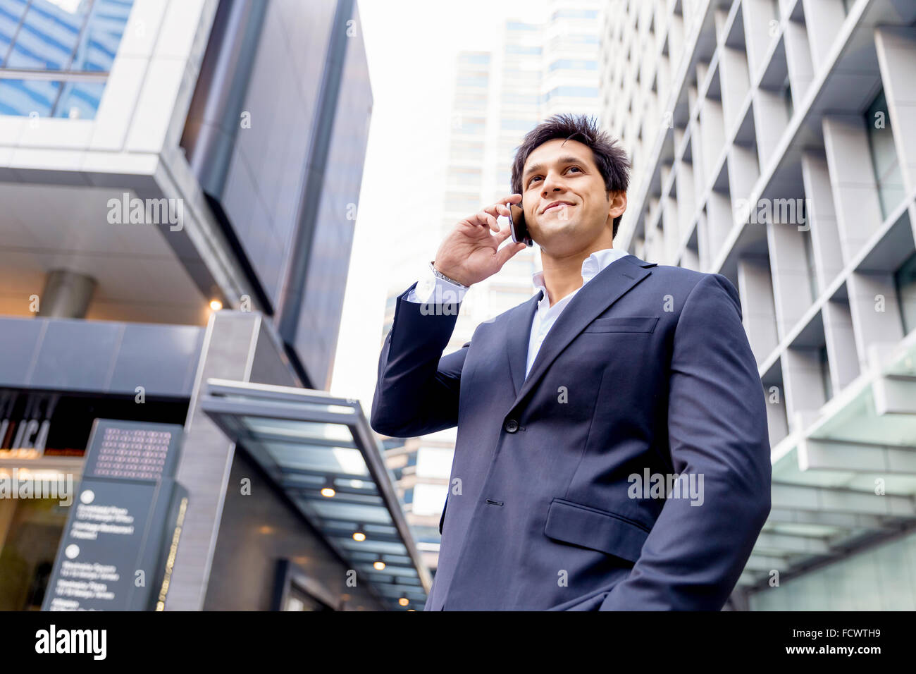 Portrait of confident businessman holding hs mobile phone outdoors Stock Photo - Alamy