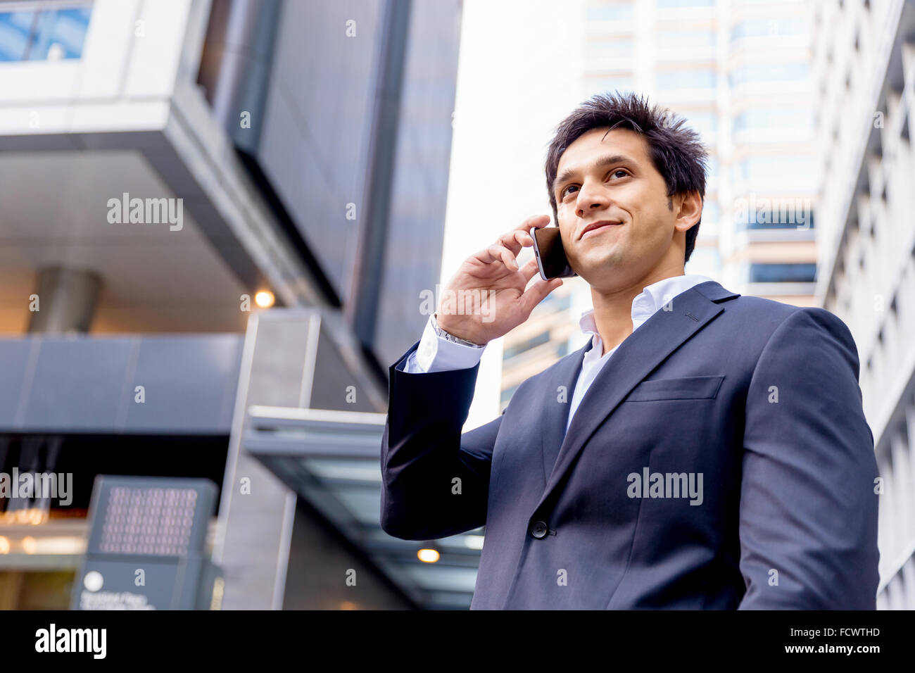 Portrait of confident businessman holding hs mobile phone outdoors Stock Photo - Alamy