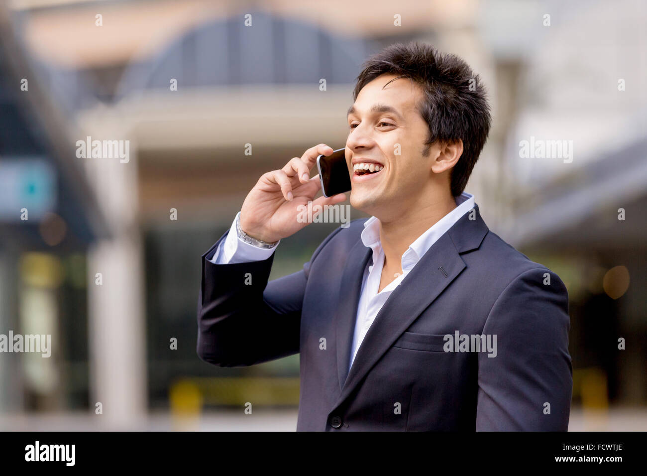 Portrait of confident businessman holding hs mobile phone outdoors Stock Photo - Alamy