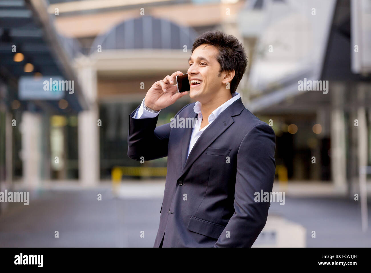 Portrait of confident businessman holding hs mobile phone outdoors Stock Photo - Alamy