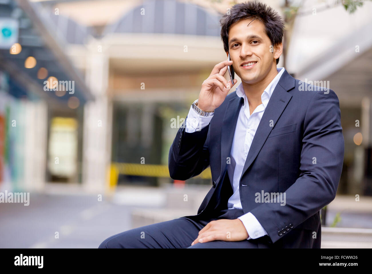 Portrait of confident businessman holding hs mobile phone outdoors Stock Photo - Alamy