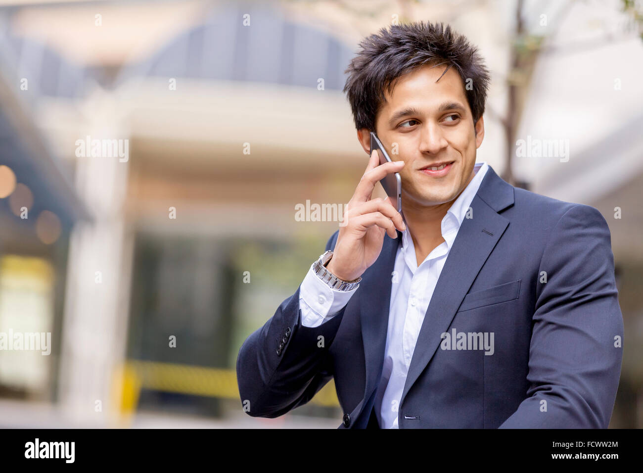 Portrait of confident businessman holding hs mobile phone outdoors Stock Photo - Alamy