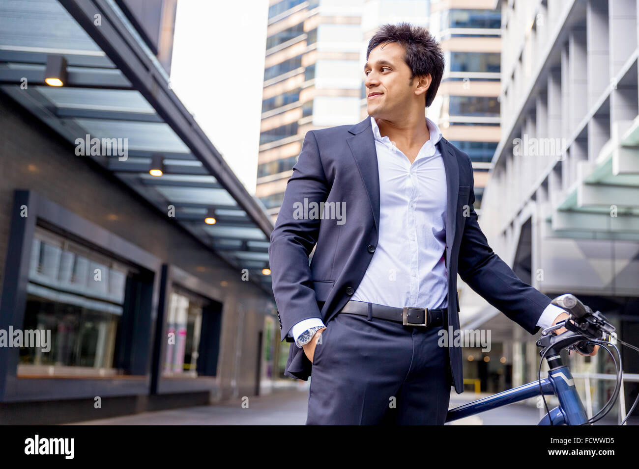 Successful businessman in suit riding bicycle Stock Photo - Alamy