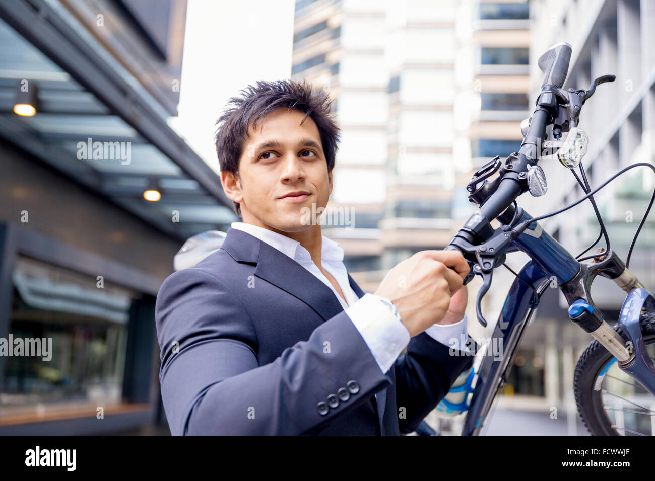 Successful businessman in suit riding bicycle Stock Photo - Alamy