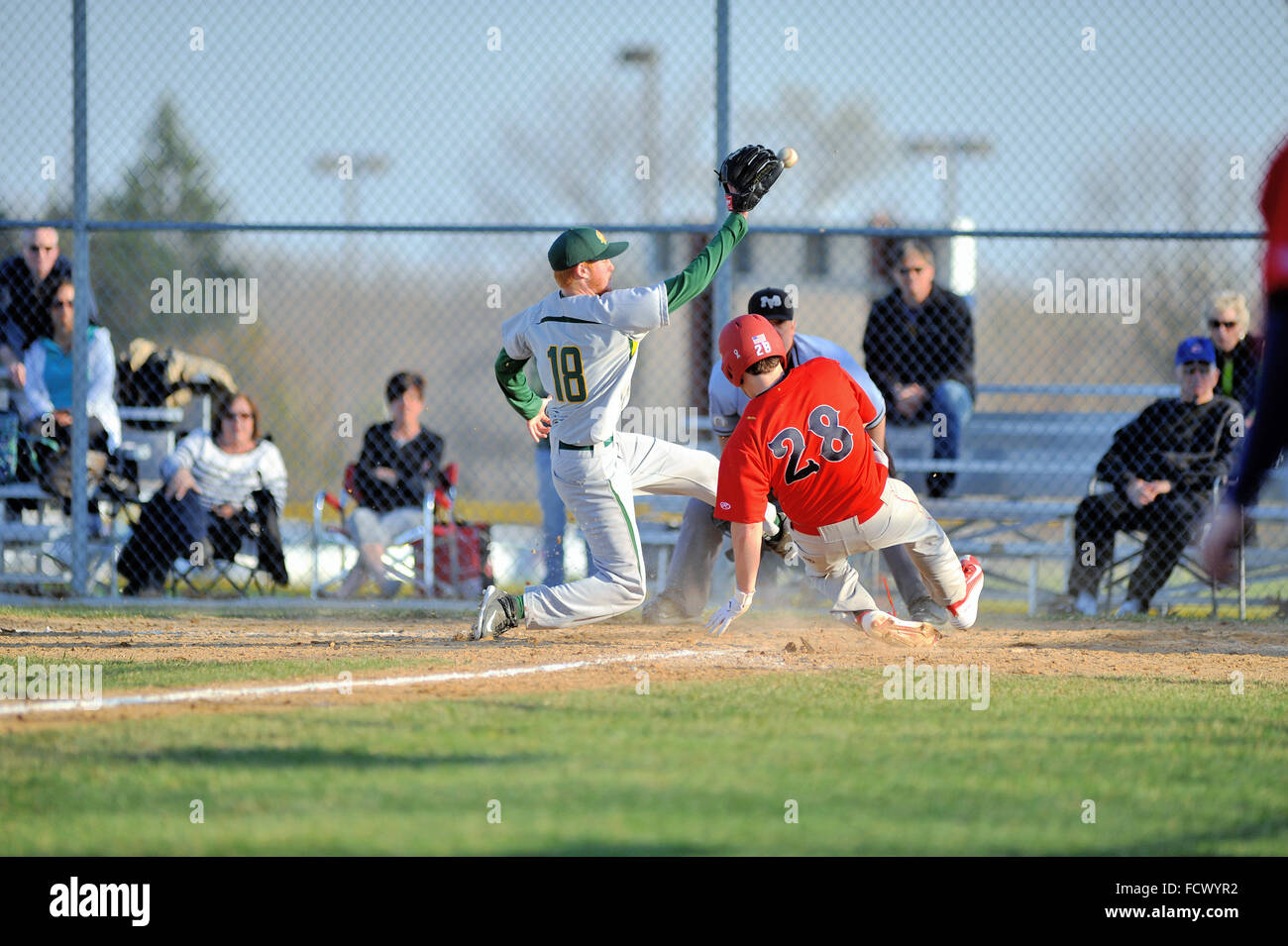 High school base runner scoring from third base on a wild pitch ahead ...