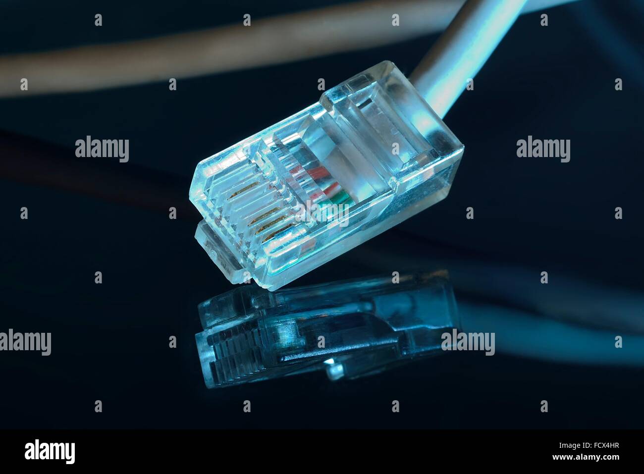 macro ethernet plug rj45 with cable on black mirror surface Stock Photo ...