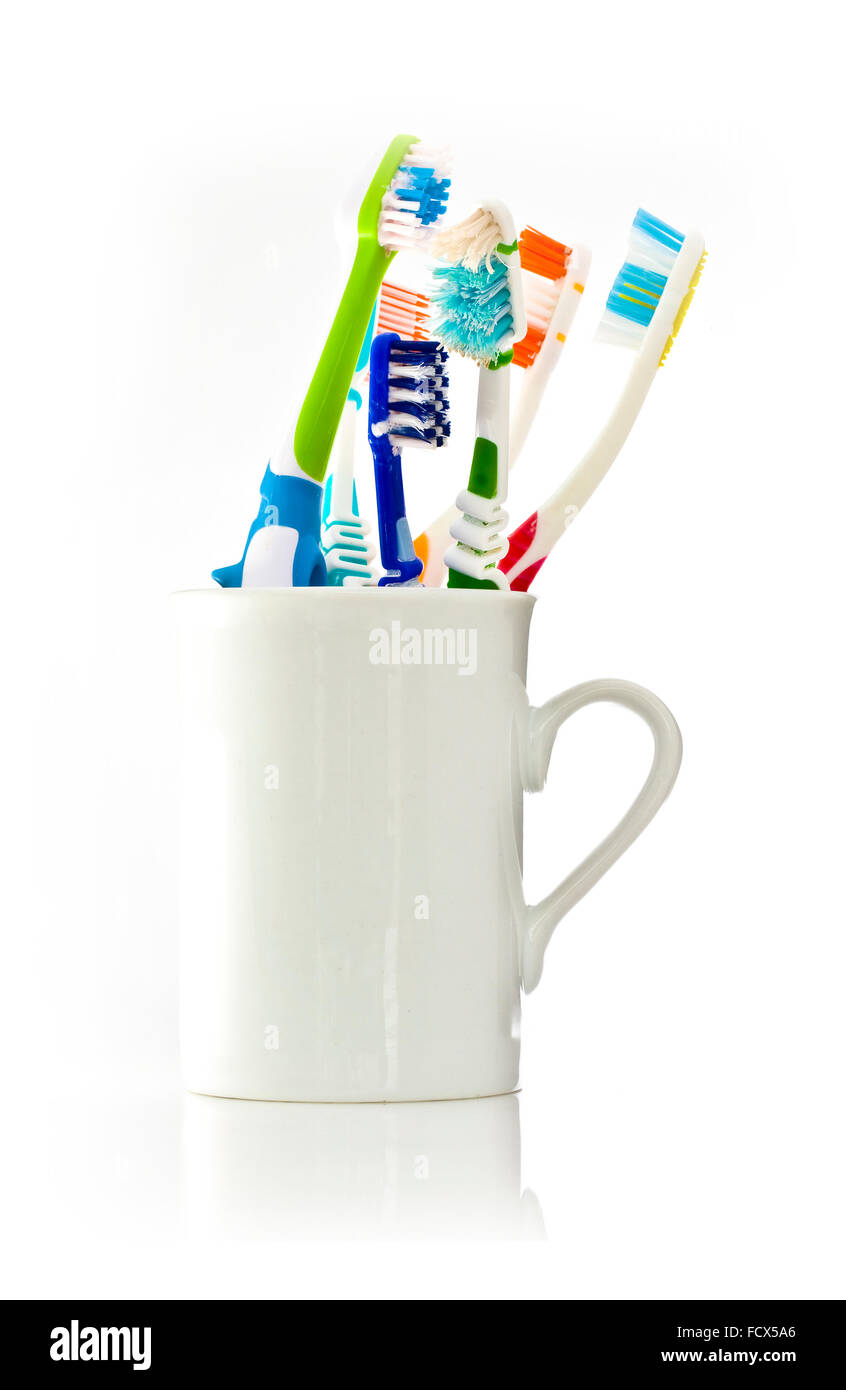 Tooth bushes in a white mug Stock Photo - Alamy