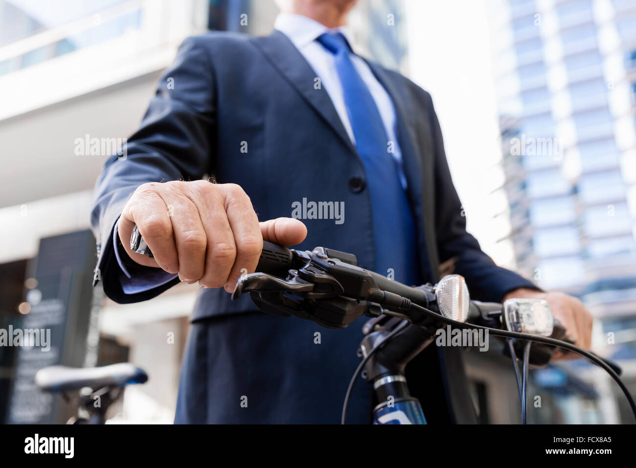 Successful businessman in suit riding bicycle Stock Photo - Alamy