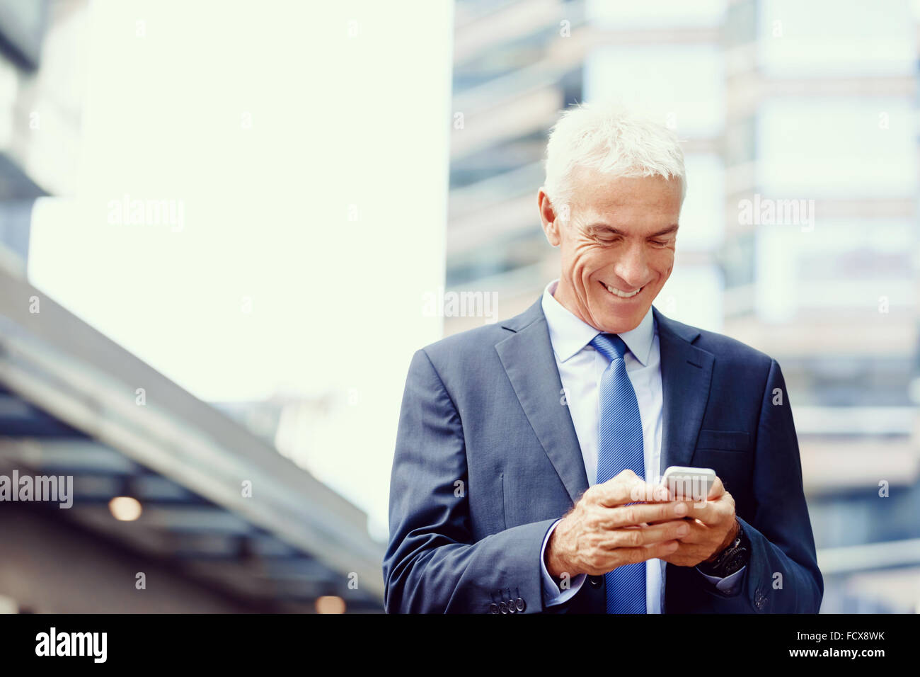 Portrait of confident businessman with his mobile phone outdoors Stock Photo - Alamy