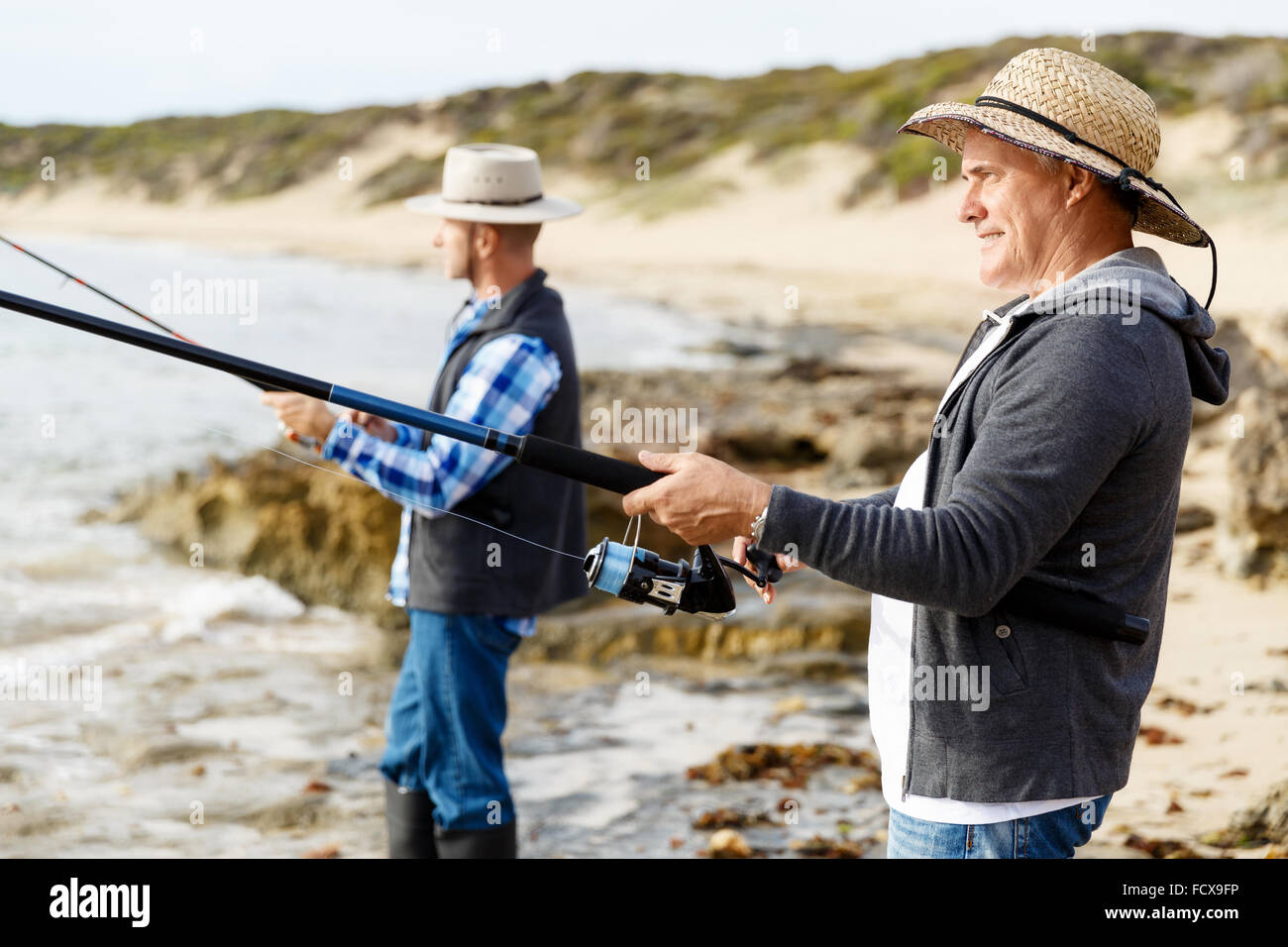 Picture of fishermen fishing with rods Stock Photo - Alamy