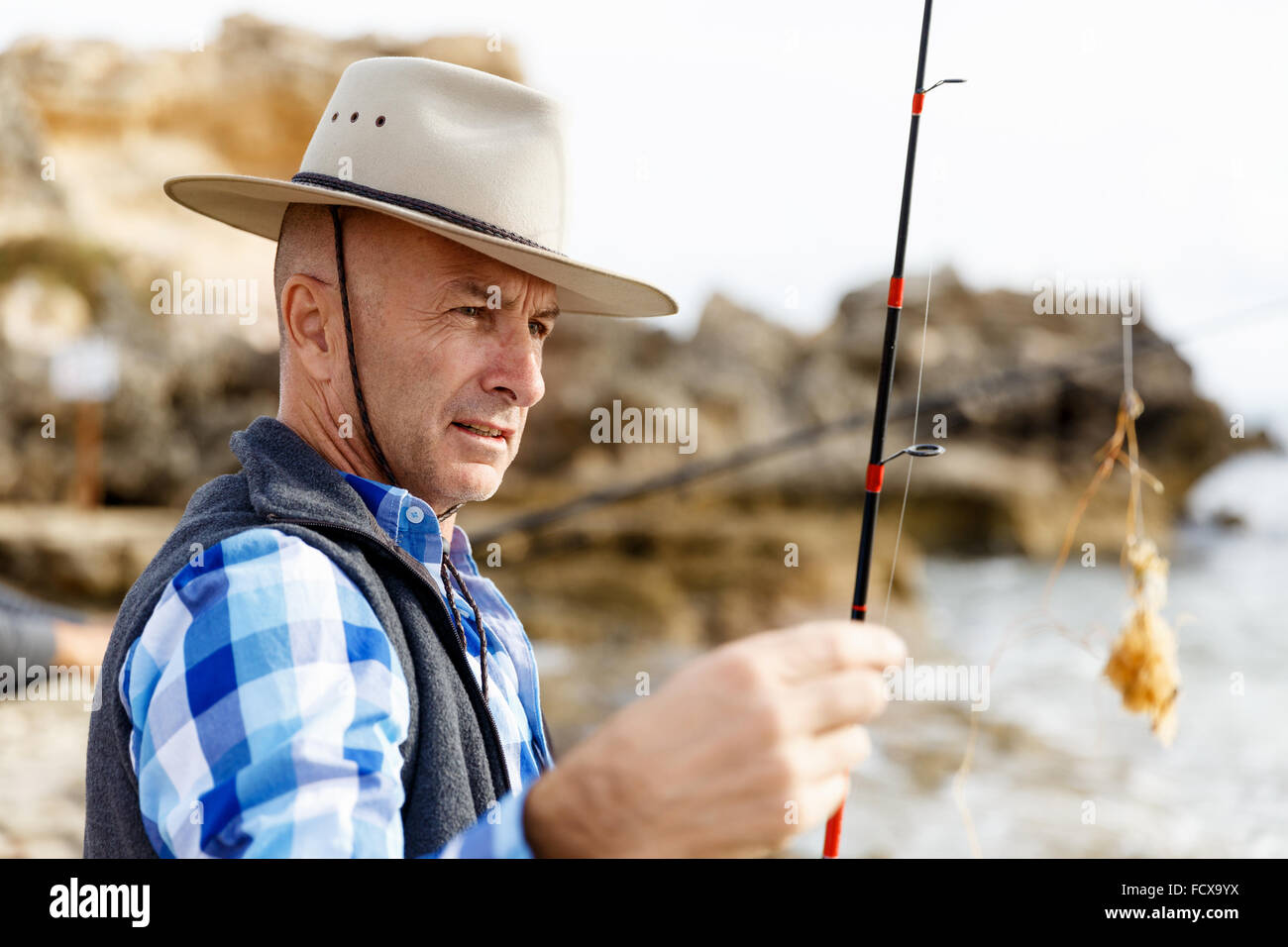 Picture of fisherman fishing with rods Stock Photo - Alamy