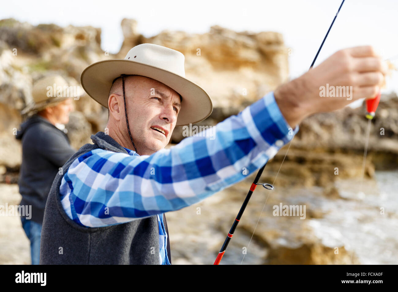 Picture of fisherman fishing with rods Stock Photo - Alamy