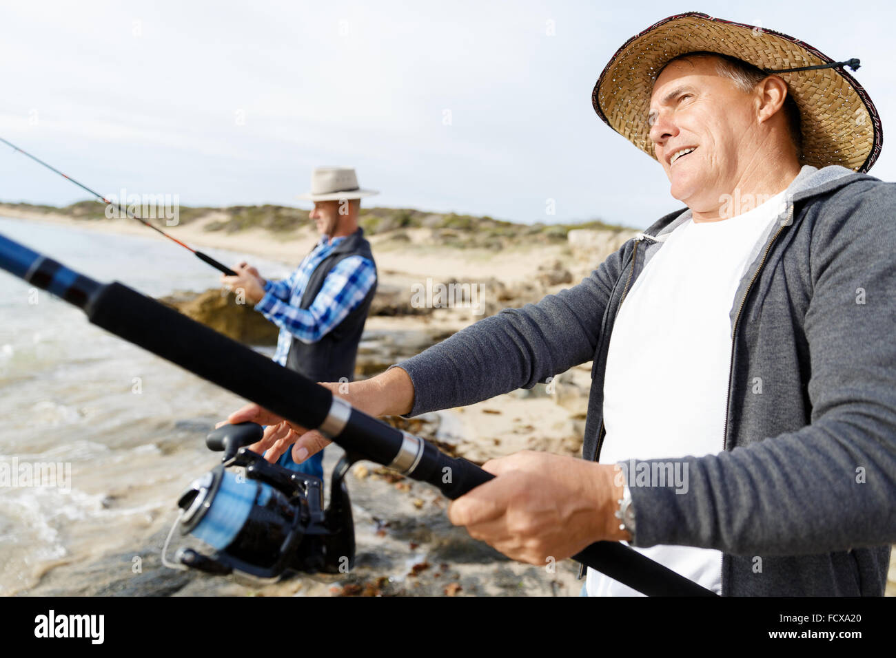 Picture of fishermen fishing with rods Stock Photo - Alamy