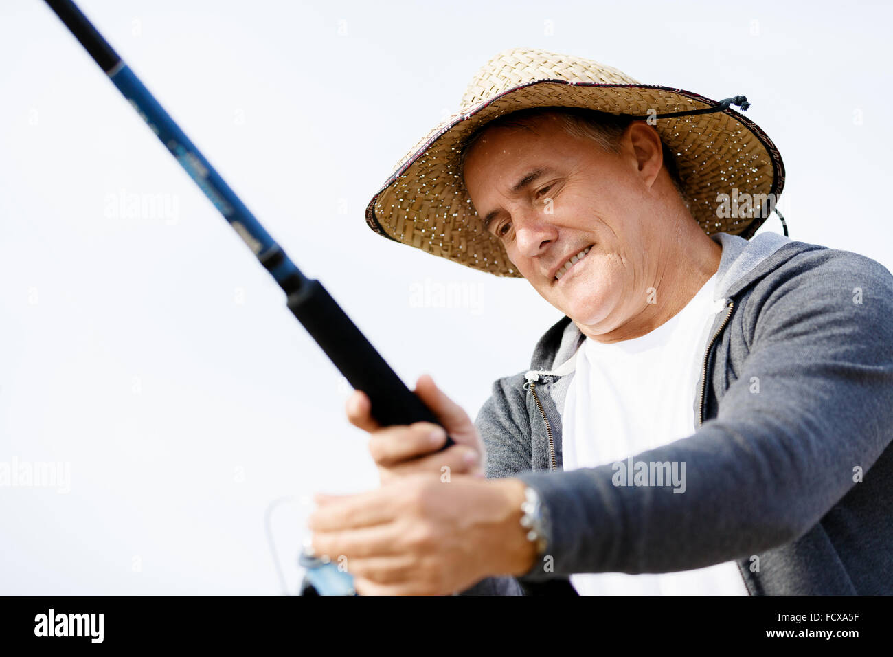 Picture of fisherman fishing with rods Stock Photo - Alamy