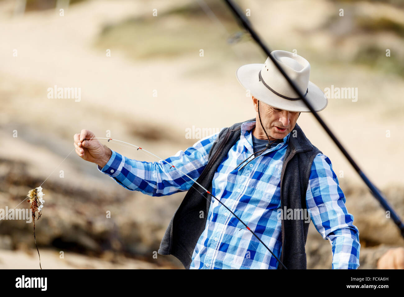 Picture of fisherman fishing with rods Stock Photo - Alamy