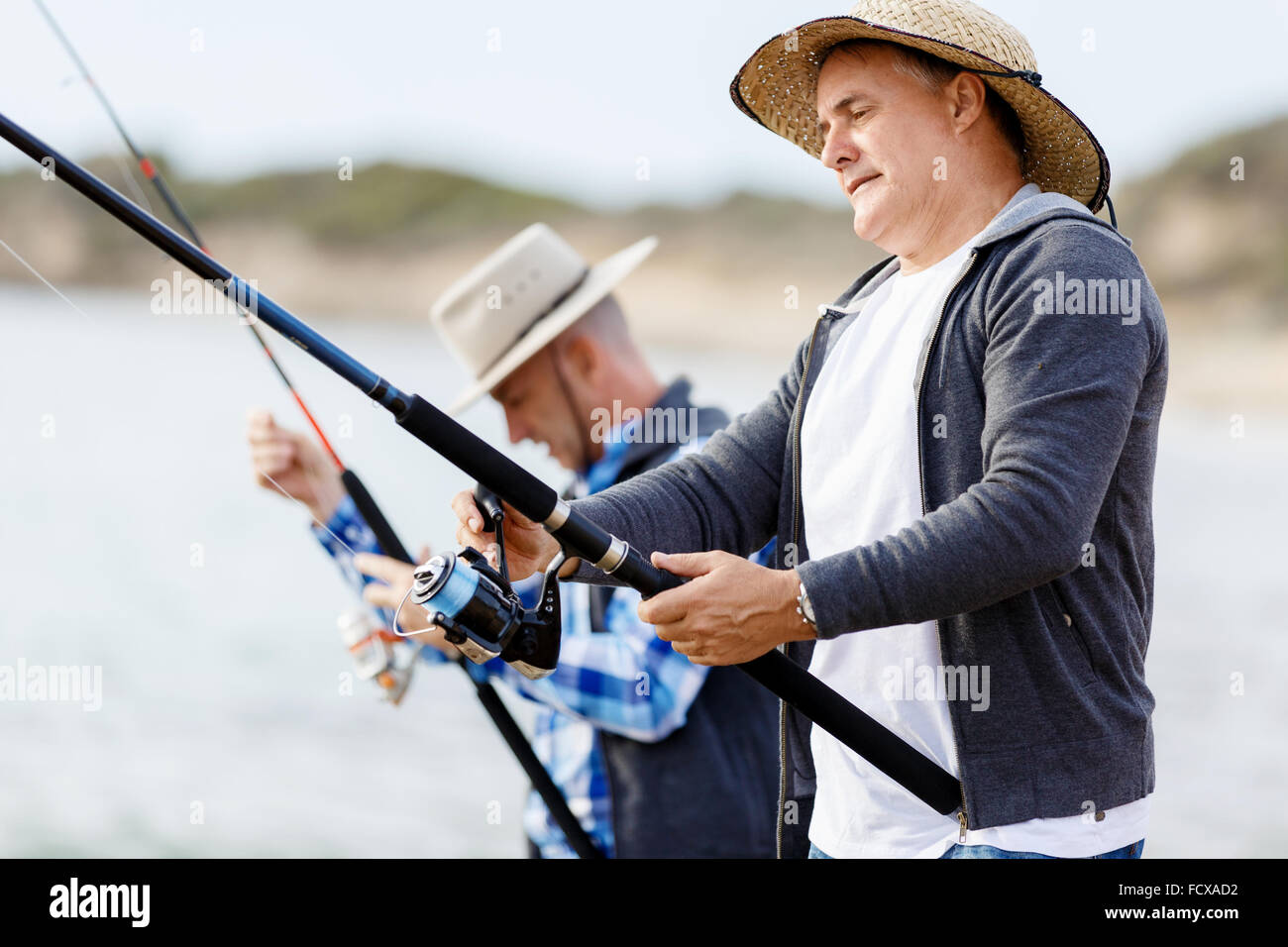 Picture of fishermen fishing with rods Stock Photo - Alamy