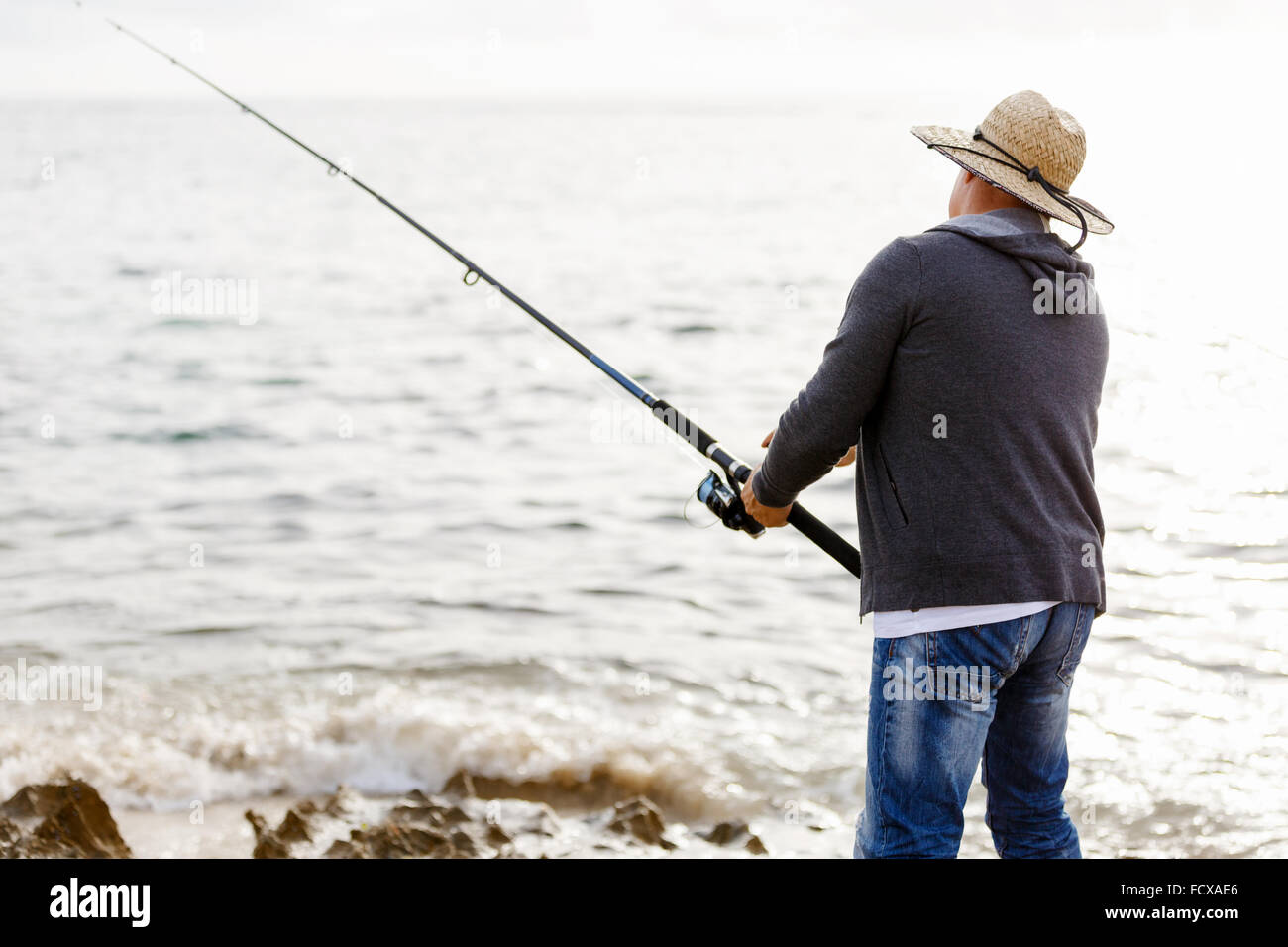 Picture of fisherman fishing with rods Stock Photo - Alamy