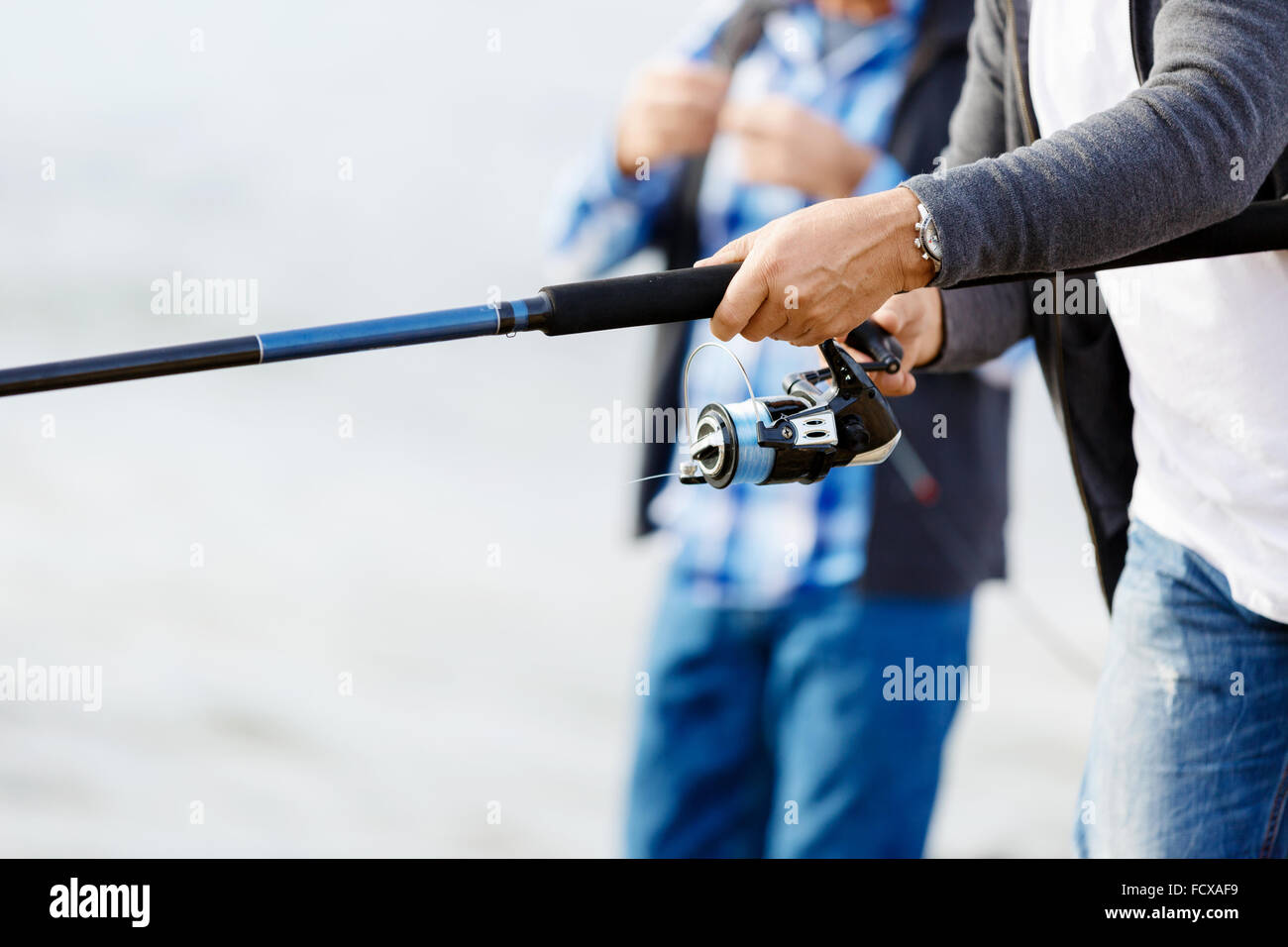 Picture of fisherman fishing with rods Stock Photo - Alamy