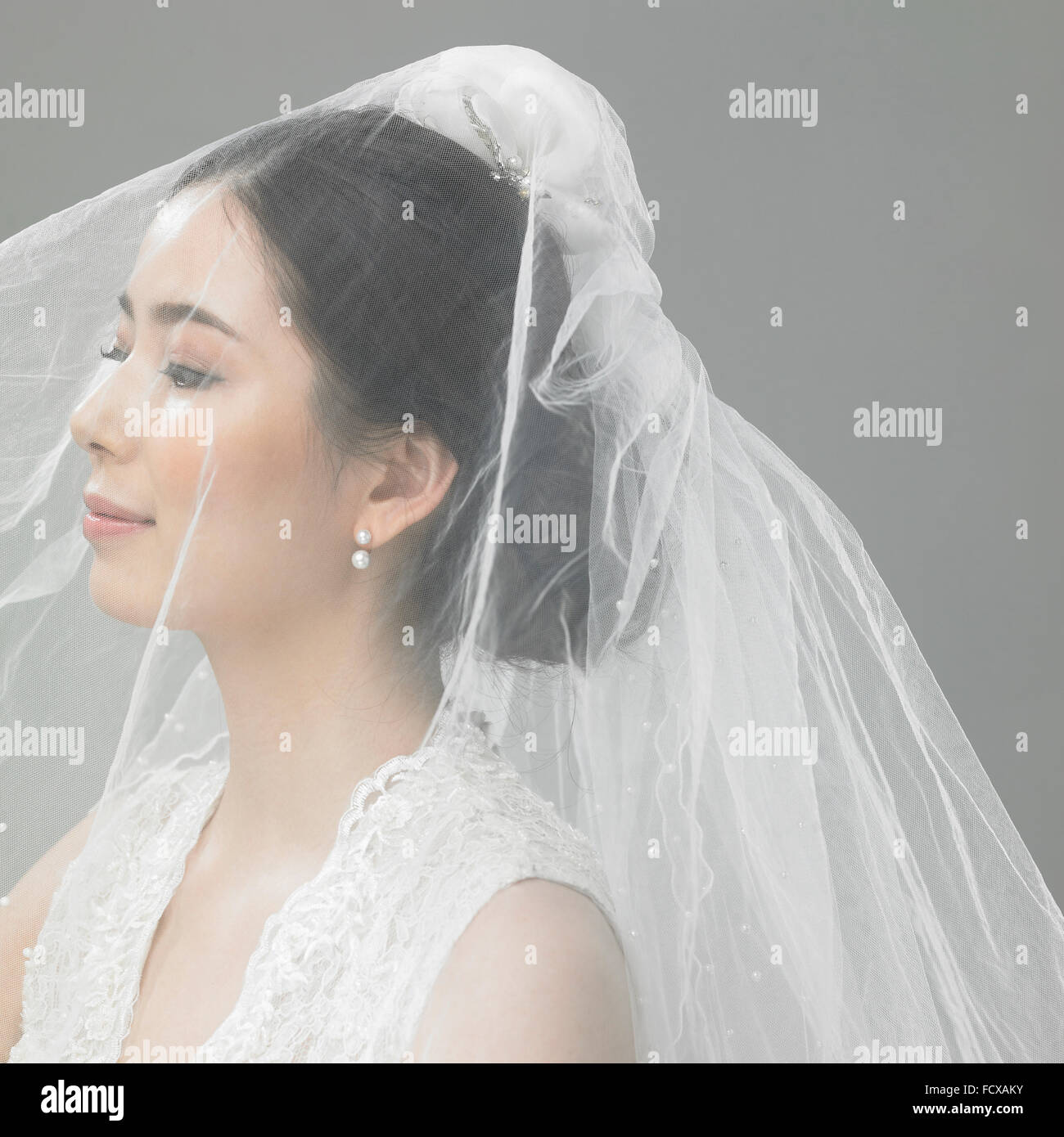 Side appearance of a bride covered with a bridal veil Stock Photo - Alamy