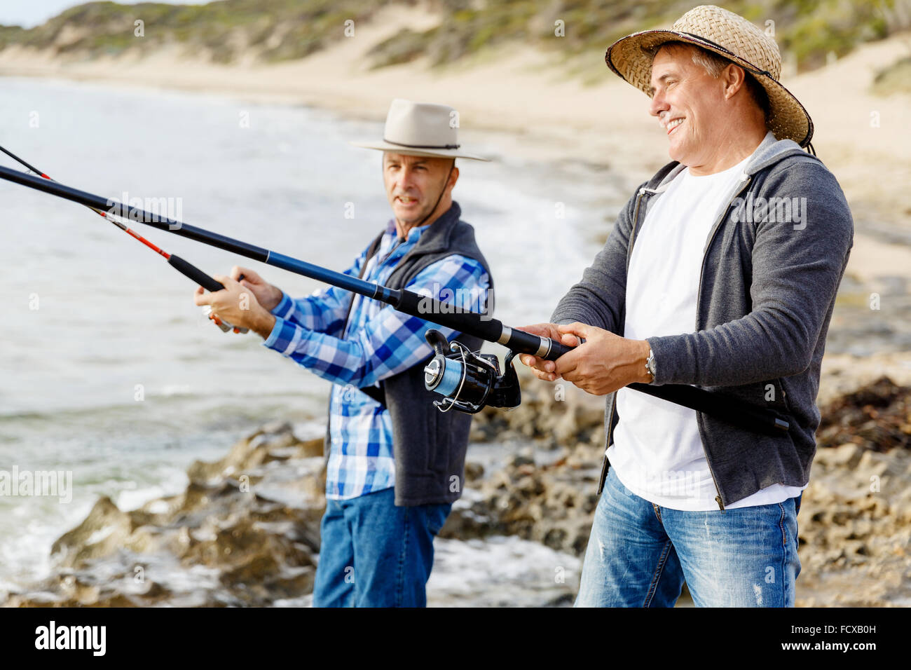 Picture of fishermen fishing with rods Stock Photo - Alamy