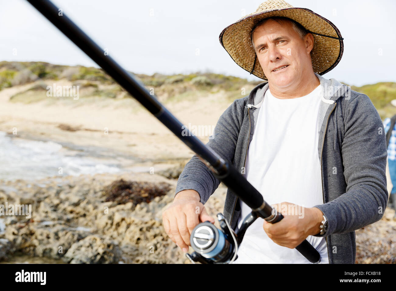 Picture of fisherman fishing with rods Stock Photo - Alamy